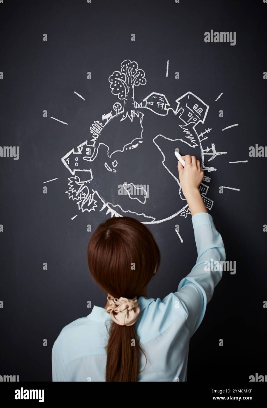 Woman drawing Earth on blackboard Stock Photo - Alamy