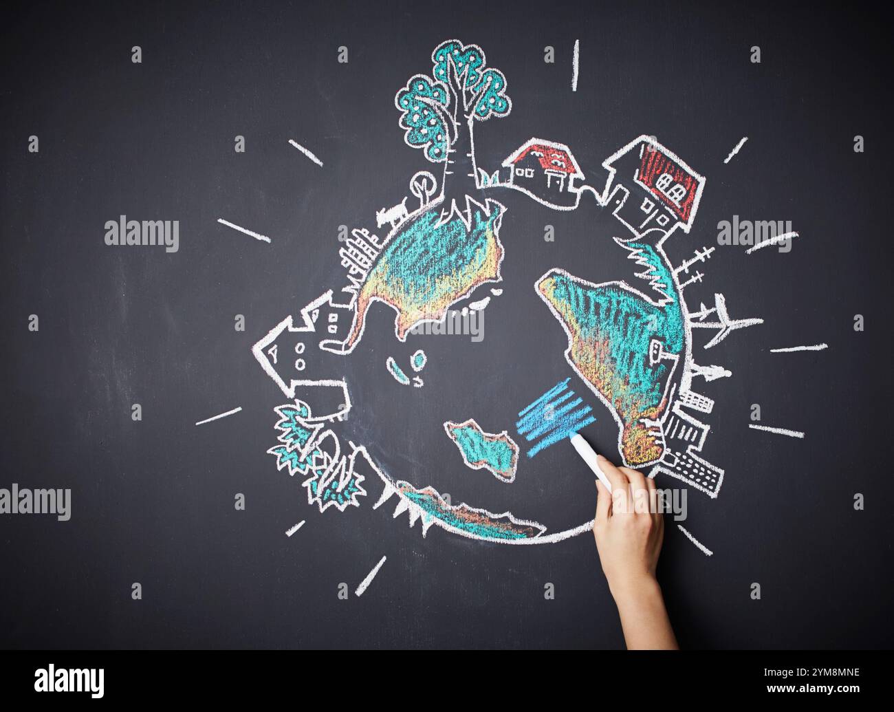 Woman drawing a picture of the earth on the blackboard Stock Photo - Alamy