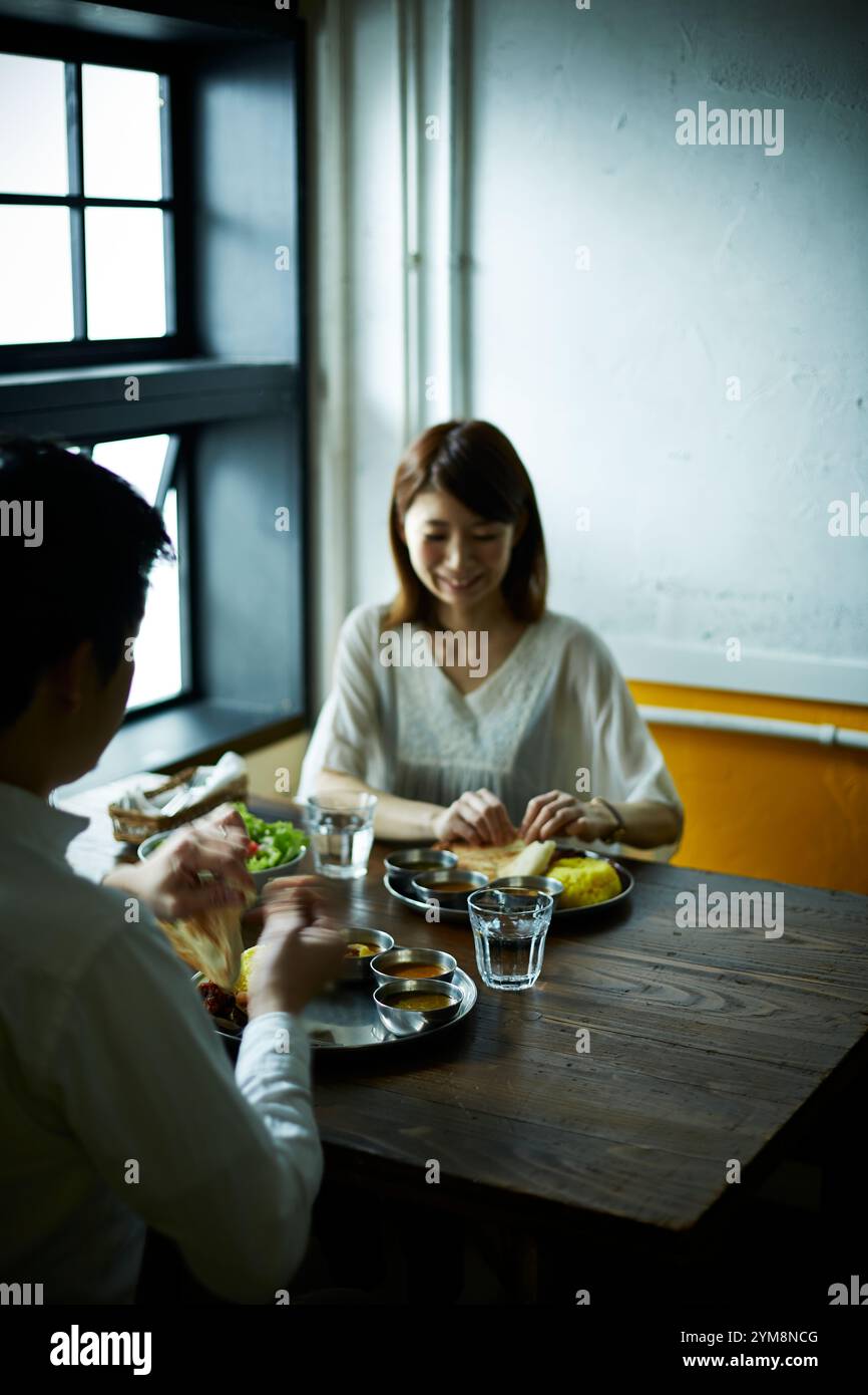 Couple eating curry Stock Photo - Alamy