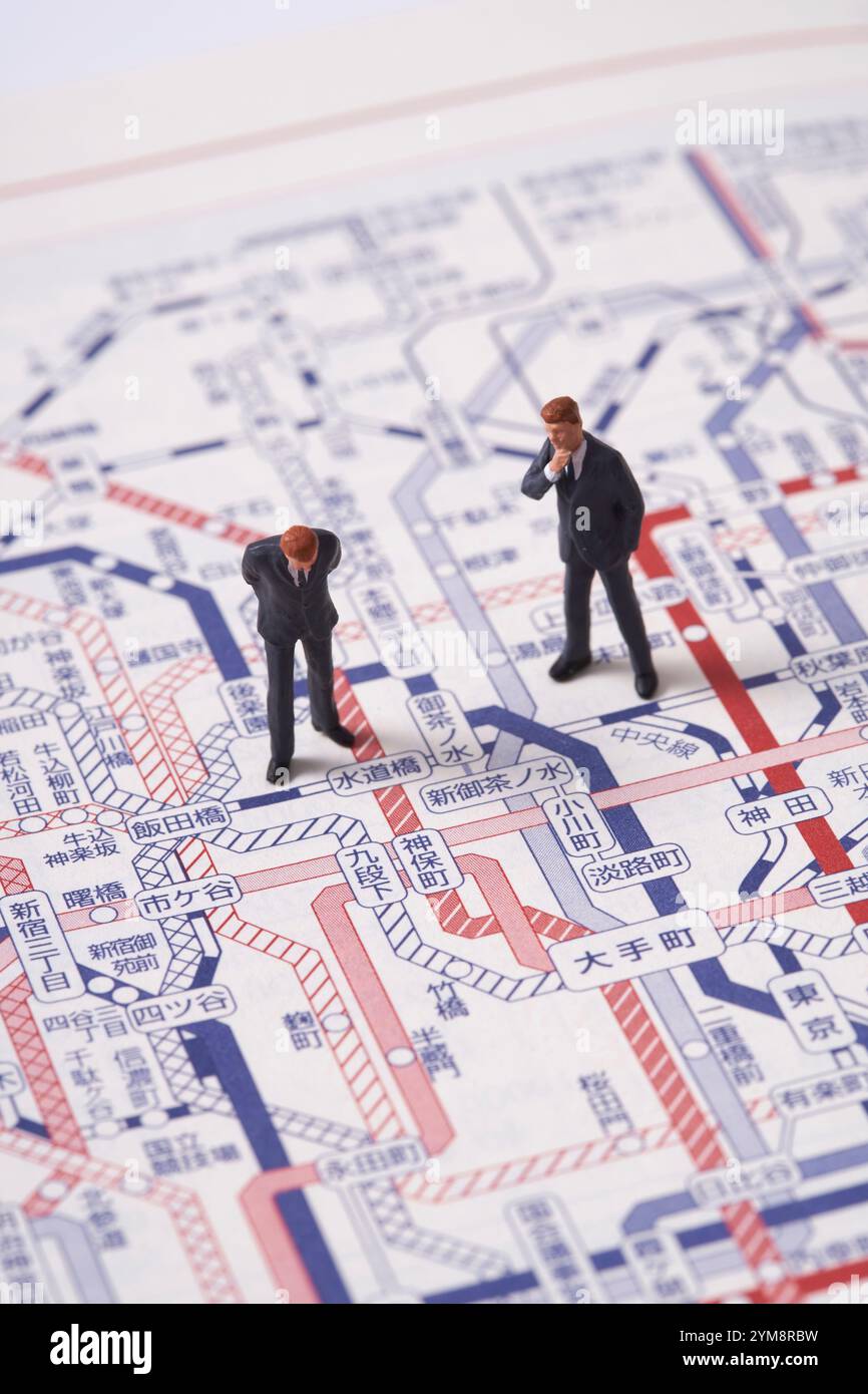 Miniature businessman doll and route map Stock Photo - Alamy