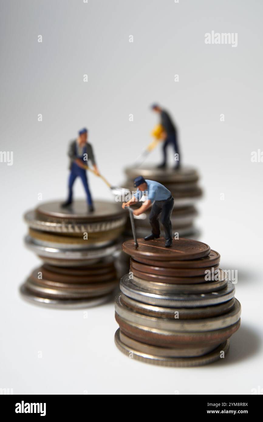Coins and miniature dolls Stock Photo - Alamy