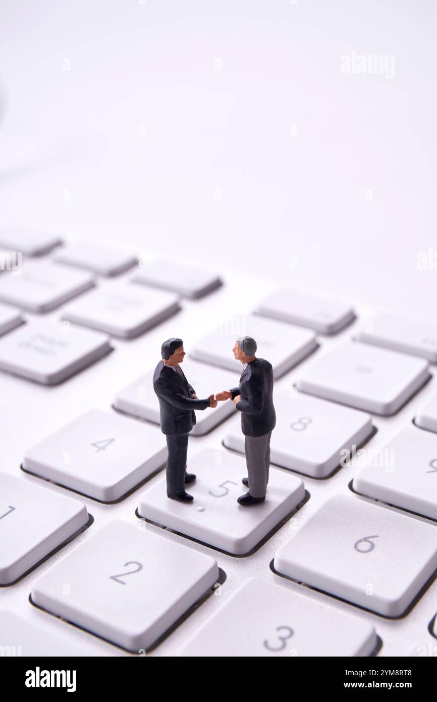 Keyboard and miniature doll Stock Photo - Alamy