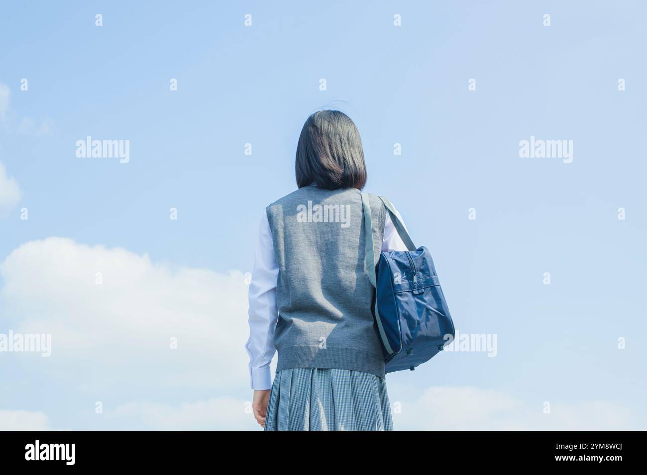 Blue sky and female junior high school student back view Stock Photo ...