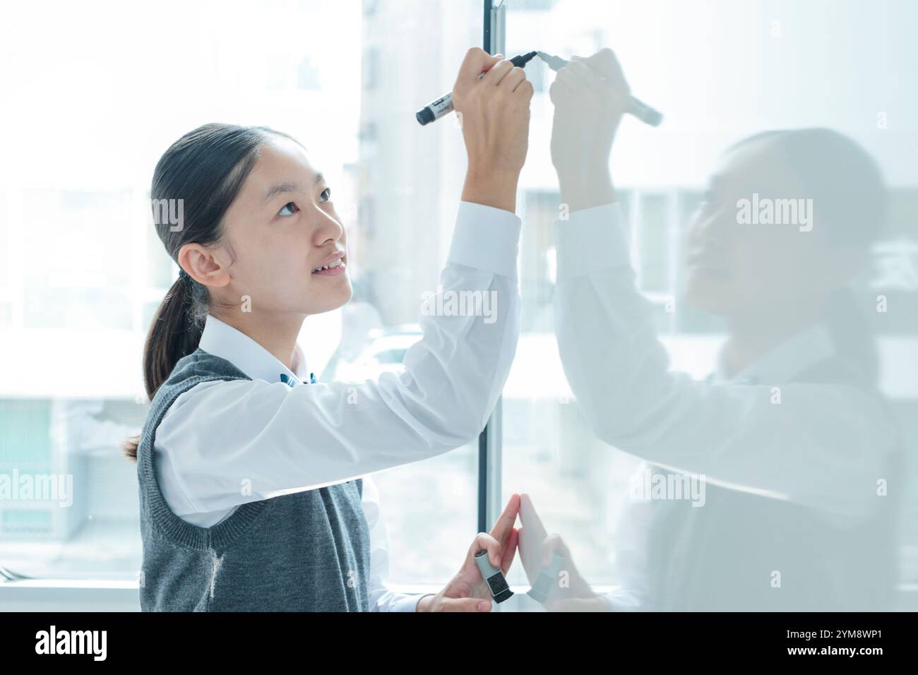 Female student holding a pen Stock Photo - Alamy