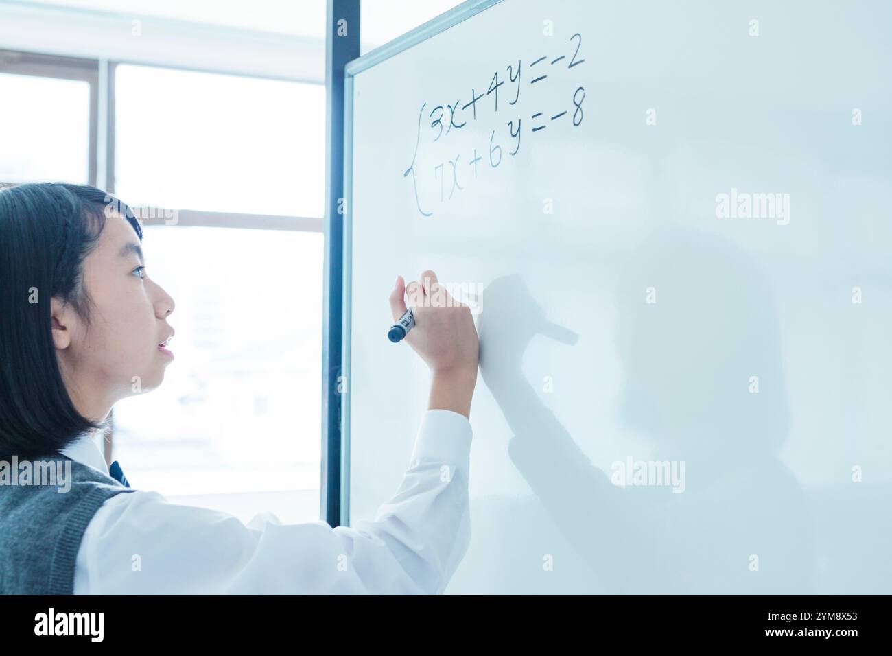 Female student holding a pen Stock Photo - Alamy