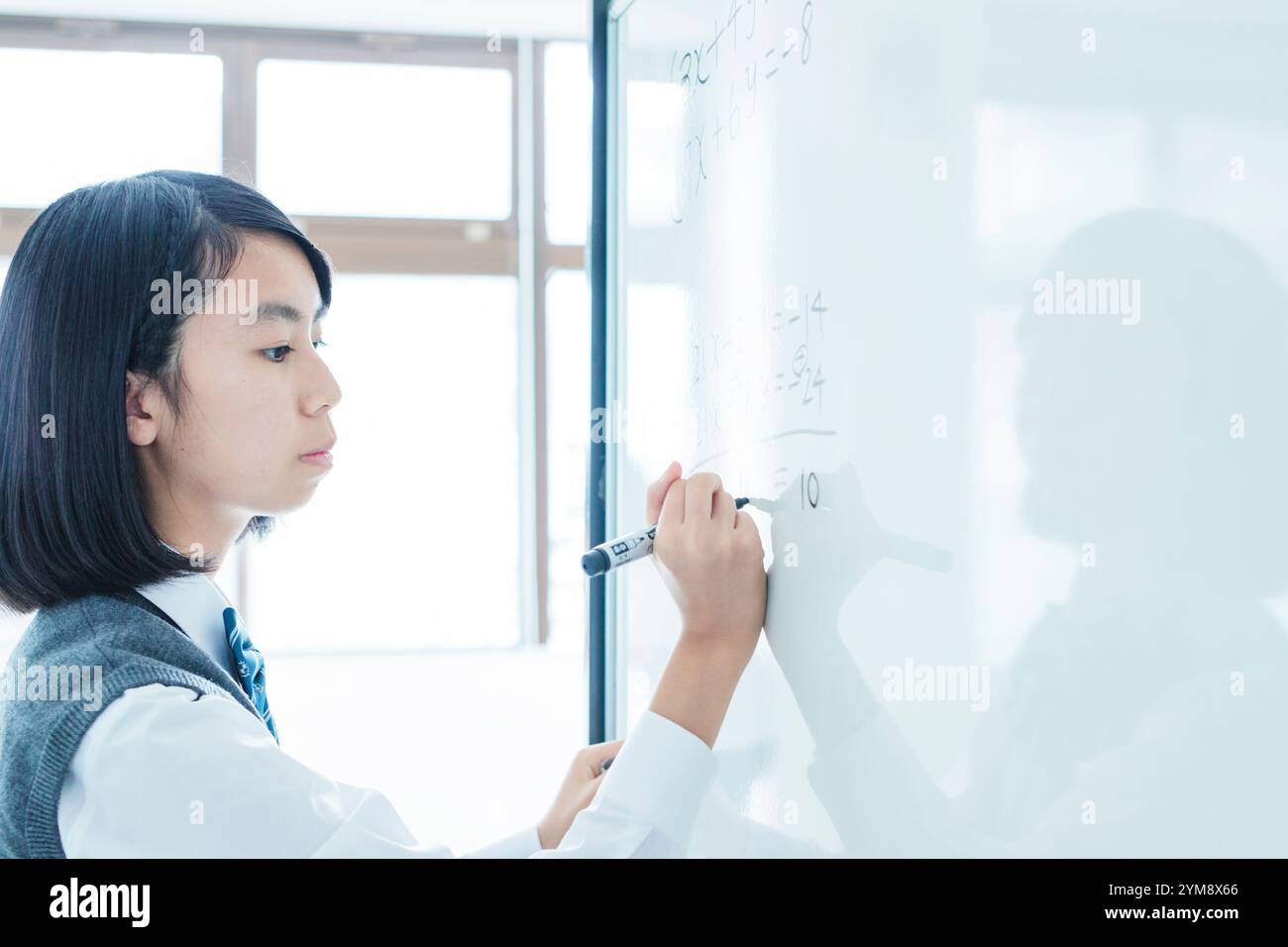 Female student holding a pen Stock Photo - Alamy