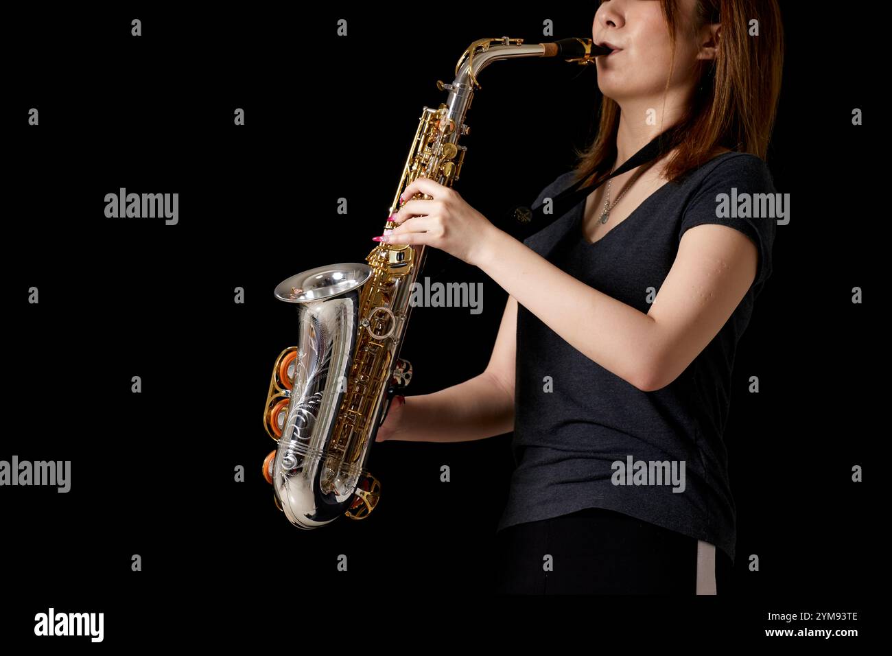 Young Japanese woman playing saxophone Stock Photo - Alamy