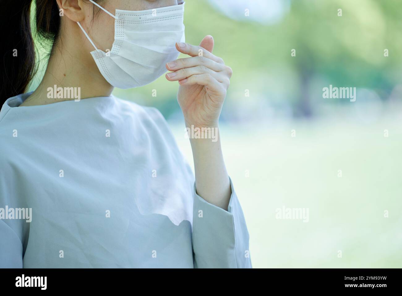 Young Japanese woman wearing a mask Stock Photo - Alamy