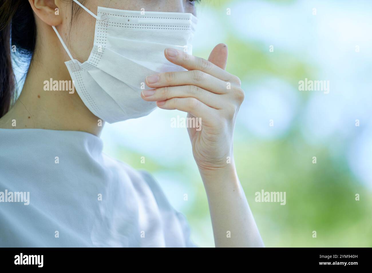 Young Japanese woman wearing a mask Stock Photo - Alamy