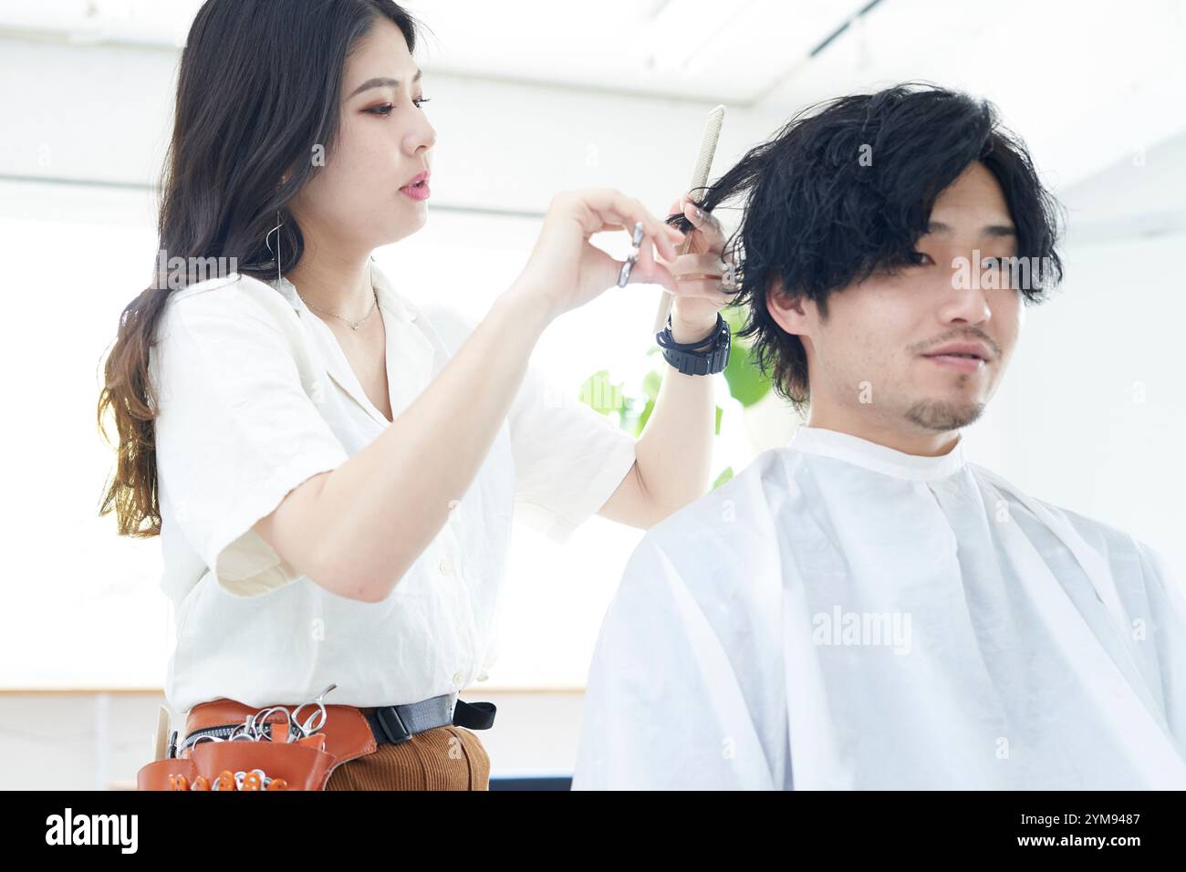 Fresh hairdresser cutting hair at a beauty salon Stock Photo - Alamy