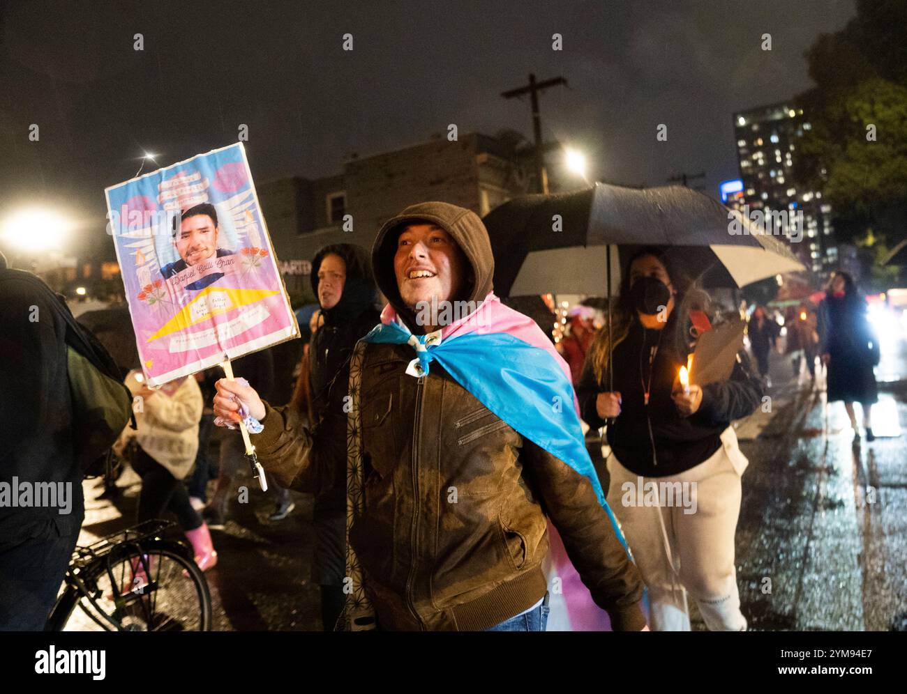 Bravery Scott holds a poster of a trans individual who passed away ...