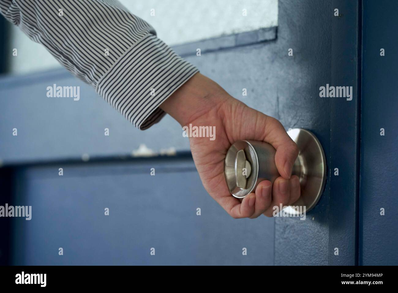 Womans hand on door knob hi-res stock photography and images - Alamy