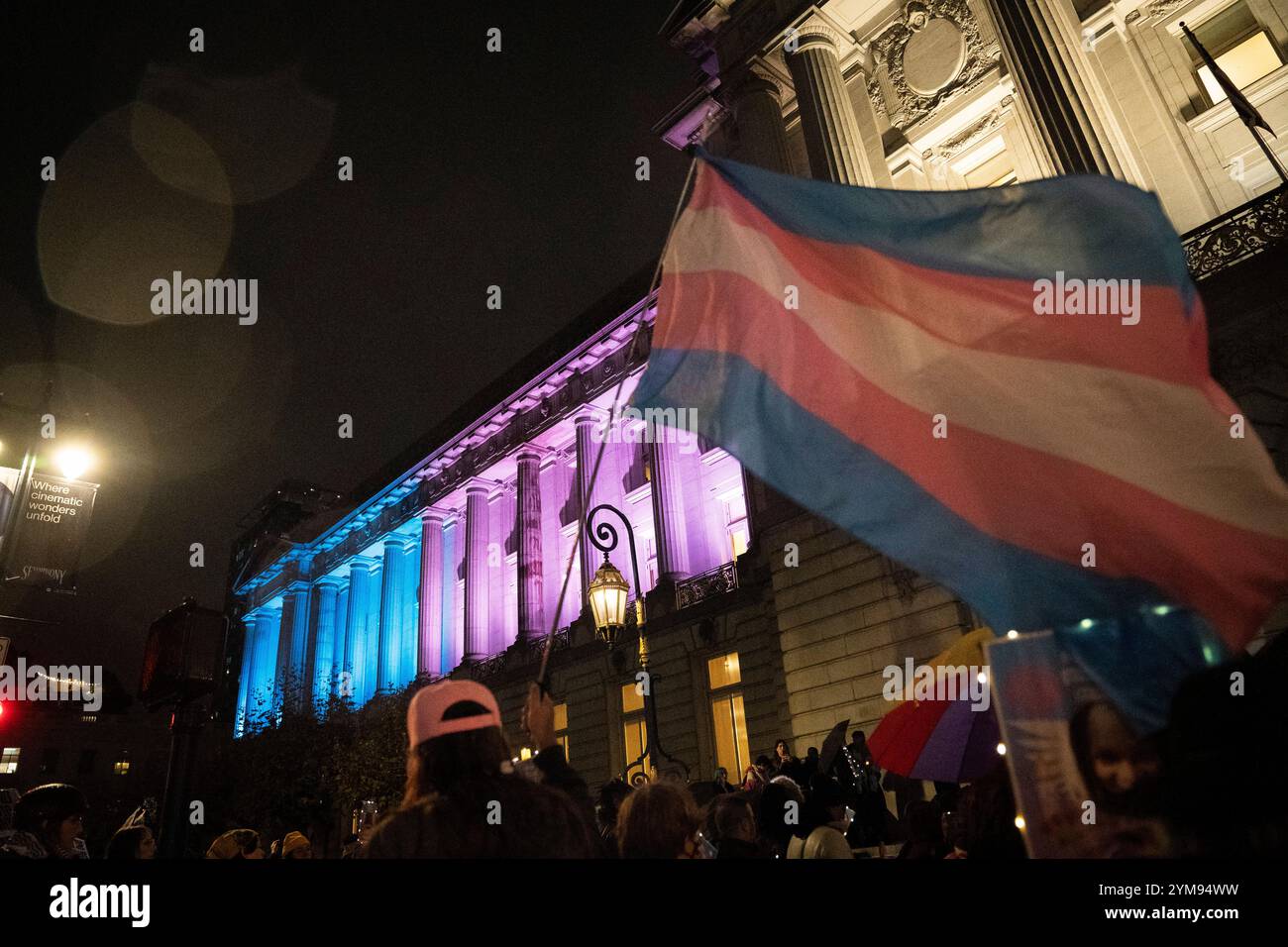 Sara Abrams holds a transgender flag during a rally to commemorate ...