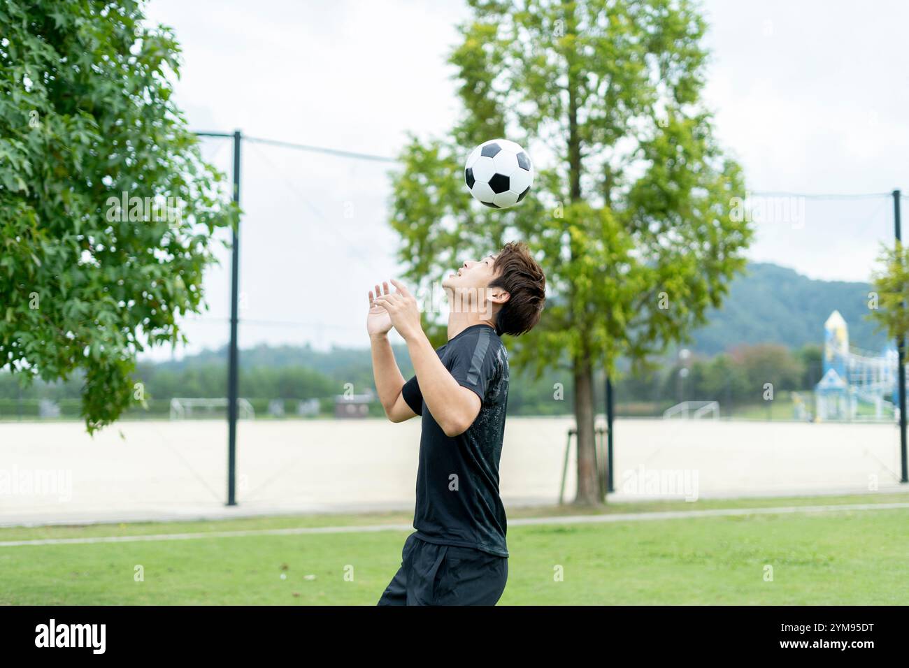 Man playing football hi-res stock photography and images - Alamy
