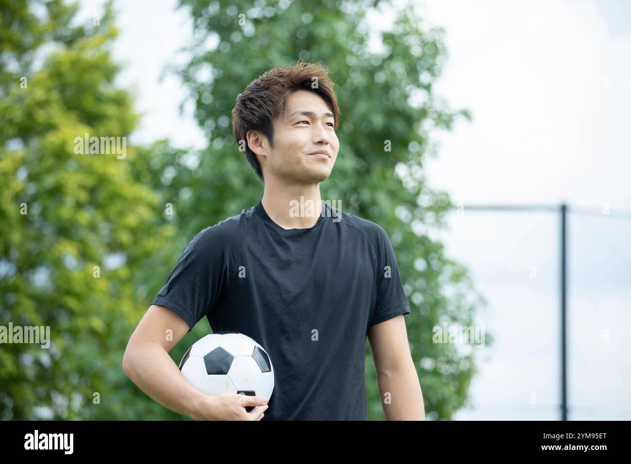Man playing football hi-res stock photography and images - Alamy