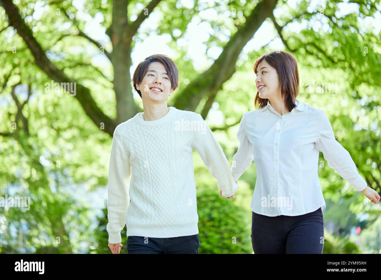 Young couple hold hands walk hi-res stock photography and images - Alamy