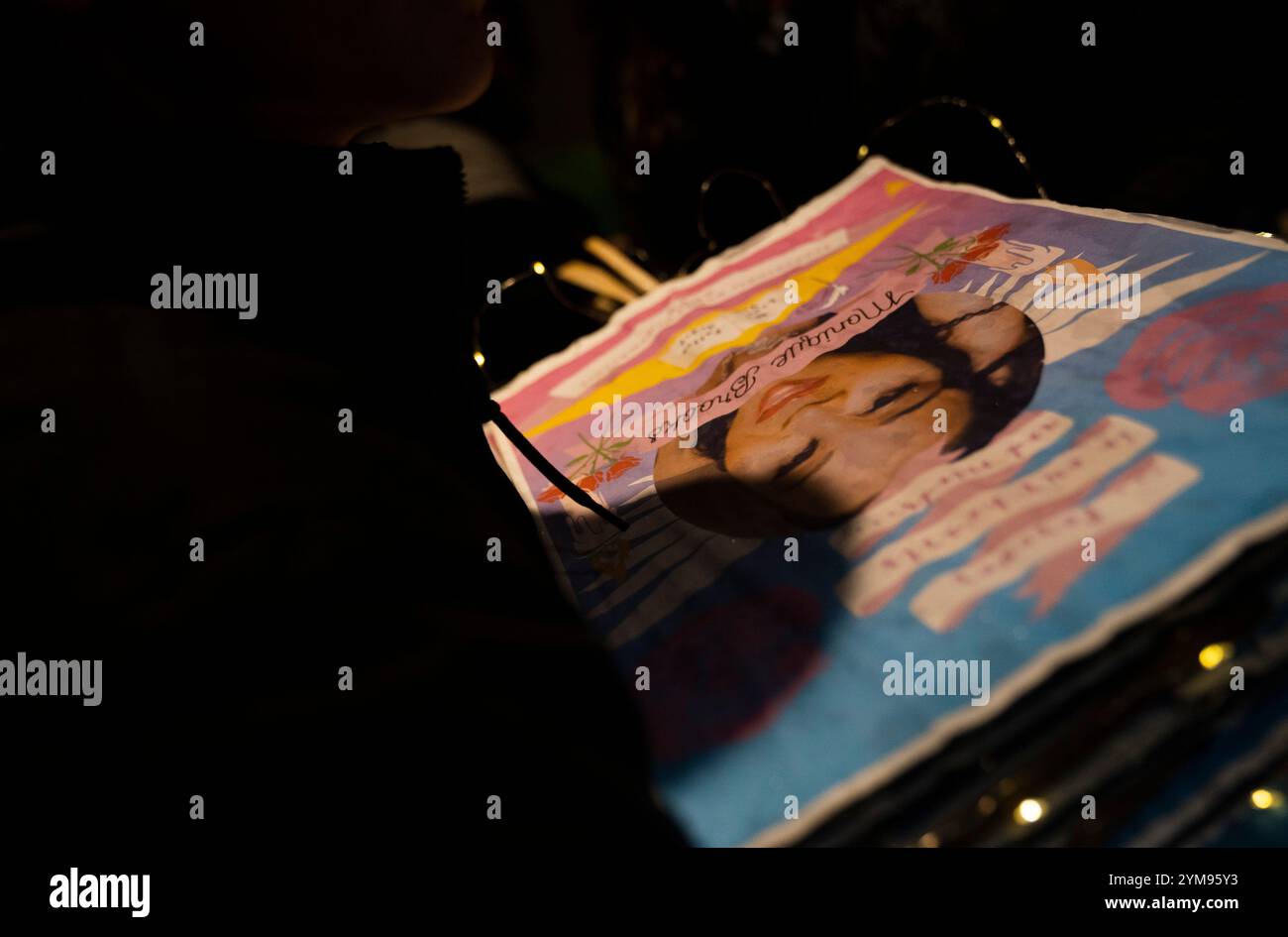 A volunteer collects posters of trans people who have passed after a ...