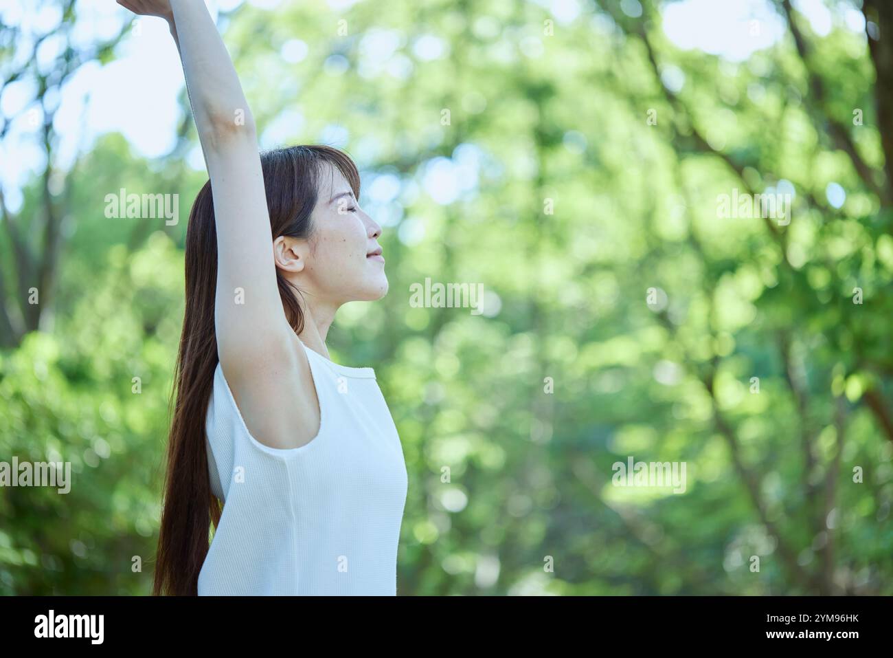 Young Japanese woman relaxing in the forest Stock Photo - Alamy