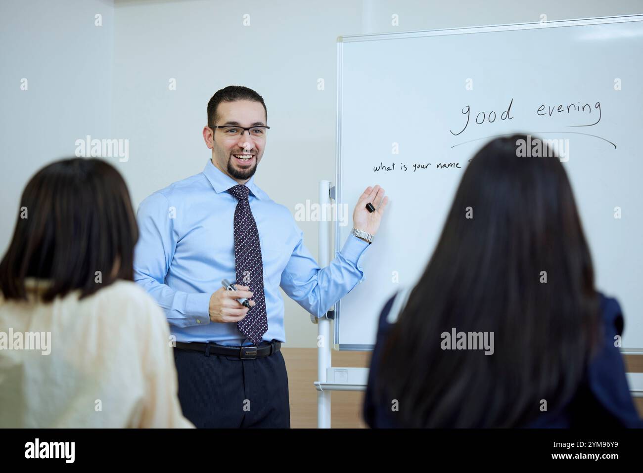 Male teacher teaching English in an English conversation class Stock ...