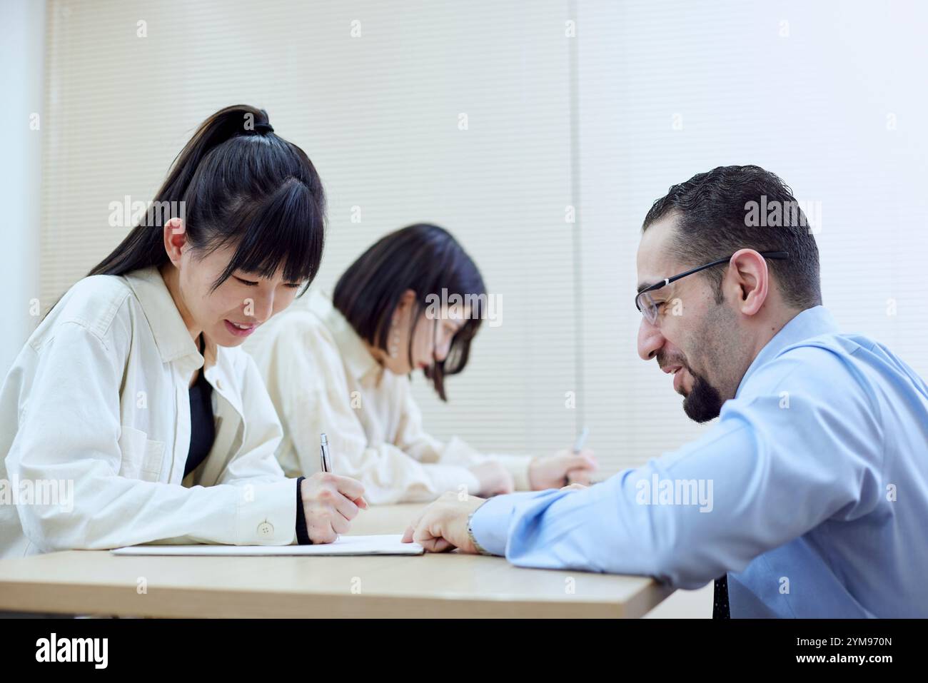 Male teacher teaching English in an English conversation class Stock ...