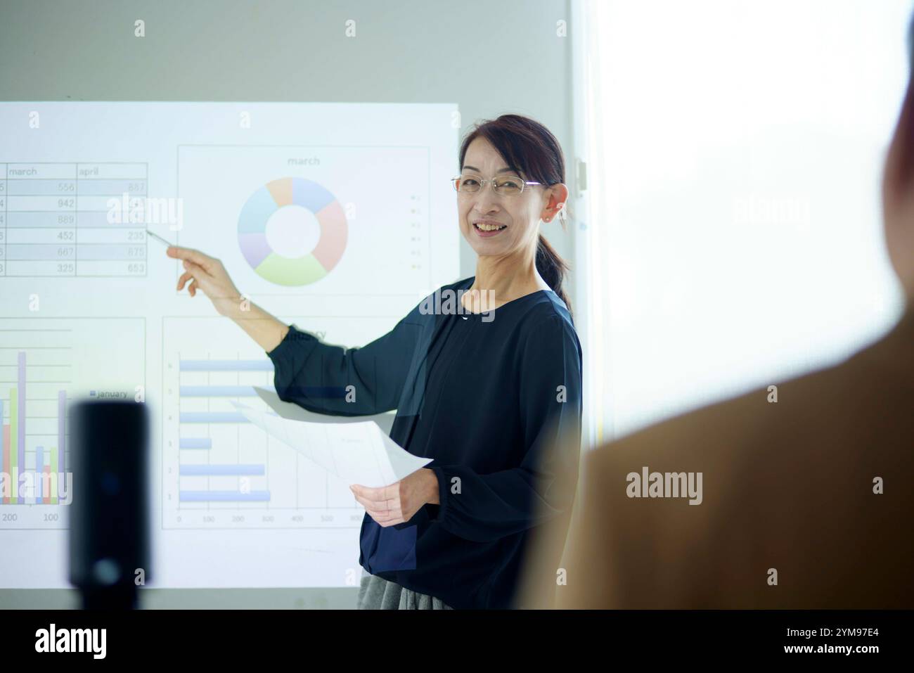 Senior Japanese woman giving a presentation in office Stock Photo - Alamy