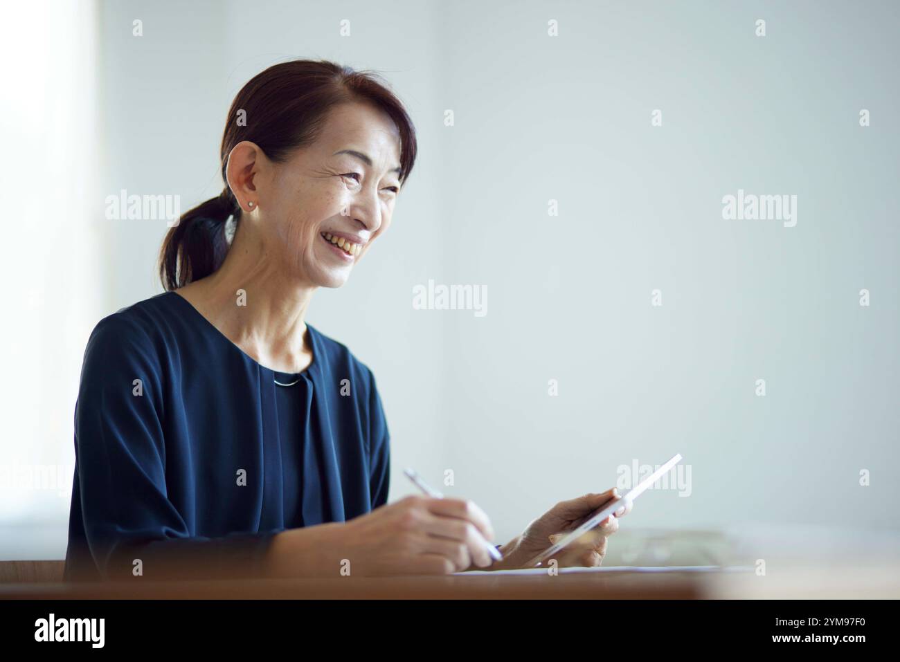 Senior Japanese woman studying using a tablet device Stock Photo - Alamy