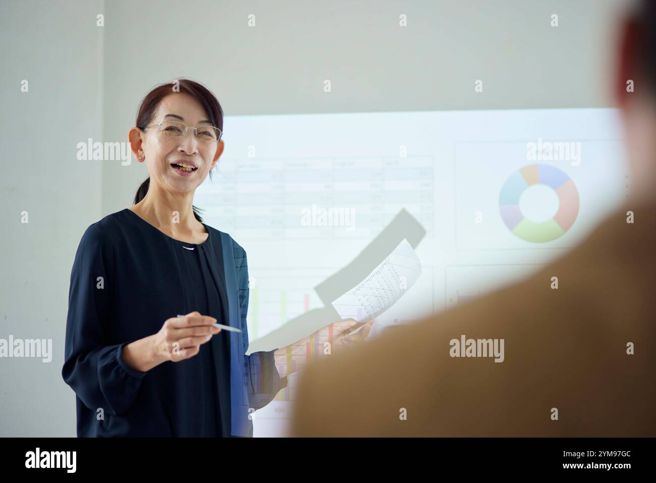 Senior Japanese woman giving a presentation in office Stock Photo - Alamy