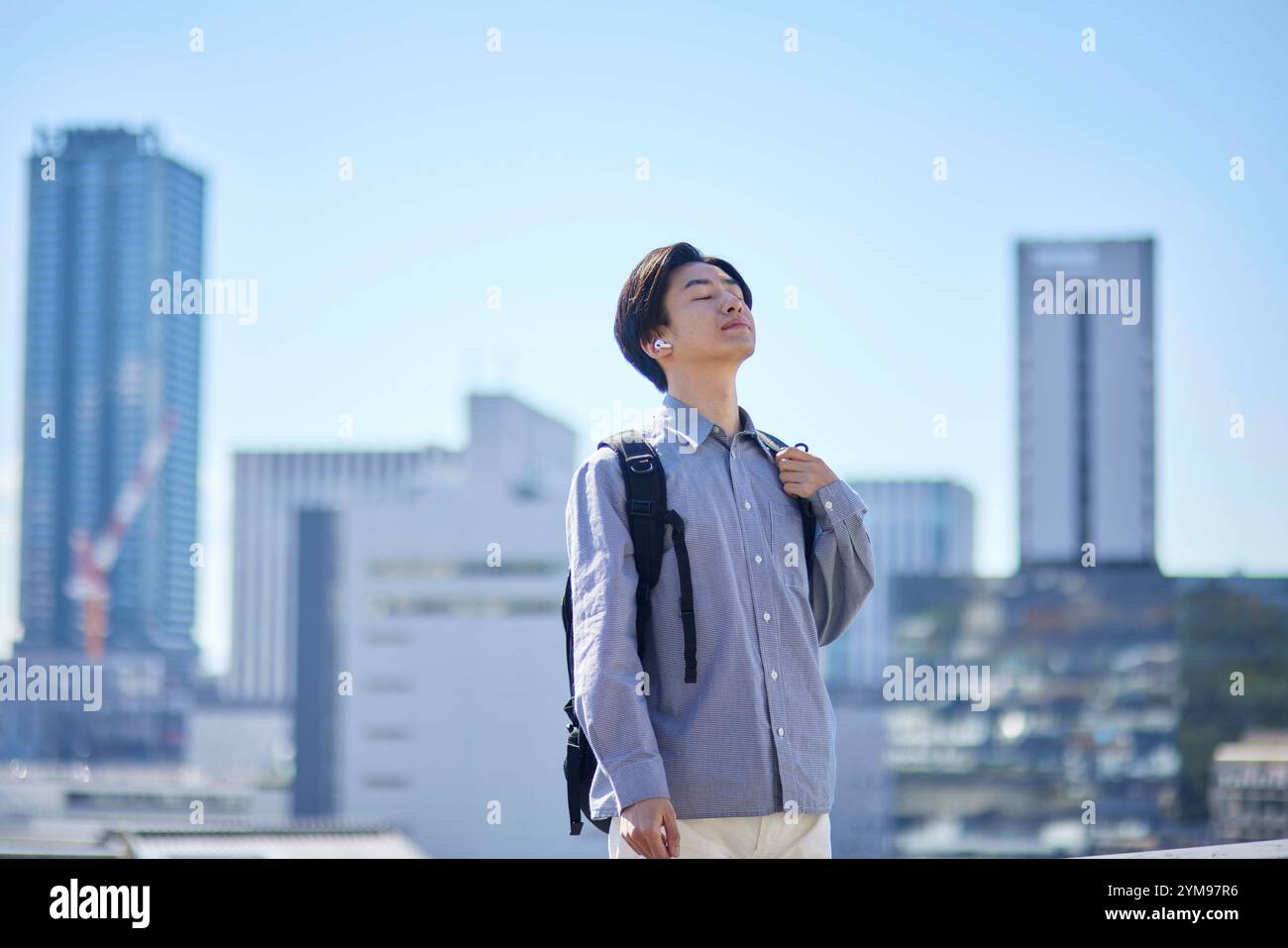 Japanese university student with backpack and townscape Stock Photo - Alamy