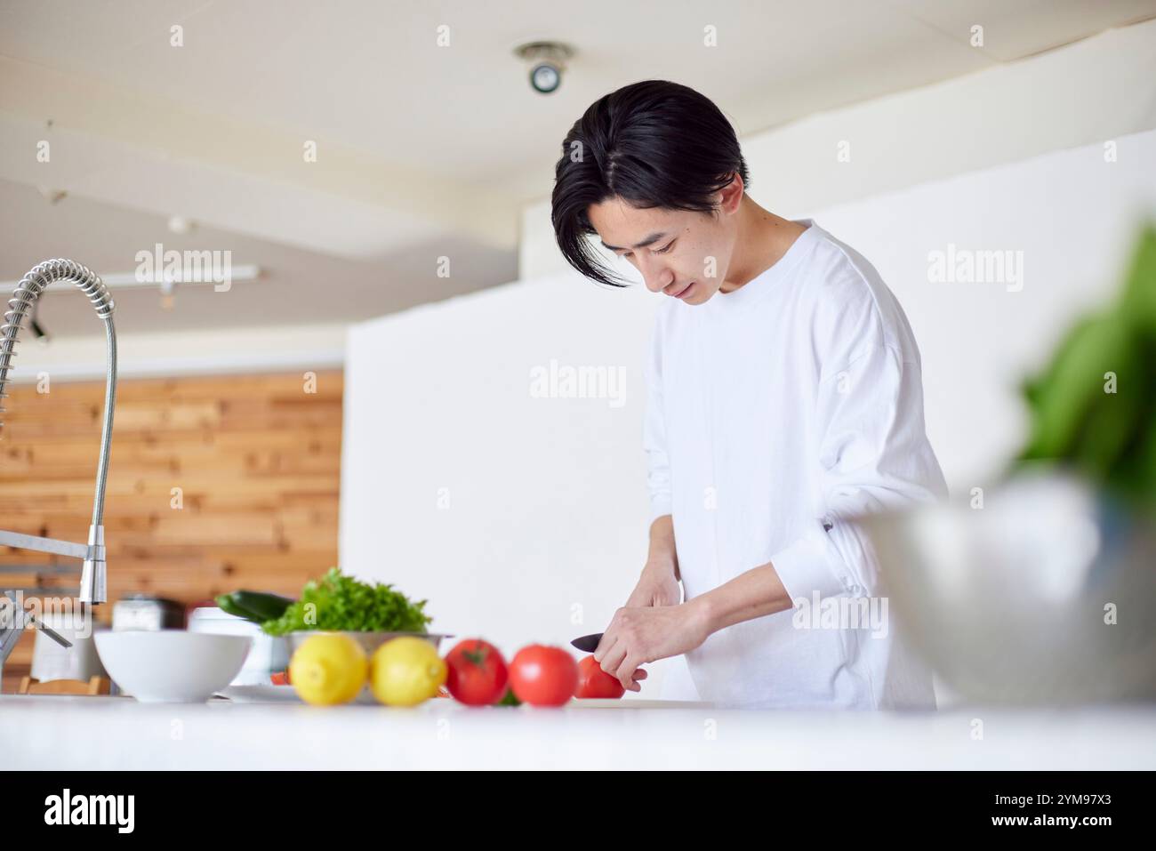 Young Japanese man cooking in the kitchen Stock Photo - Alamy