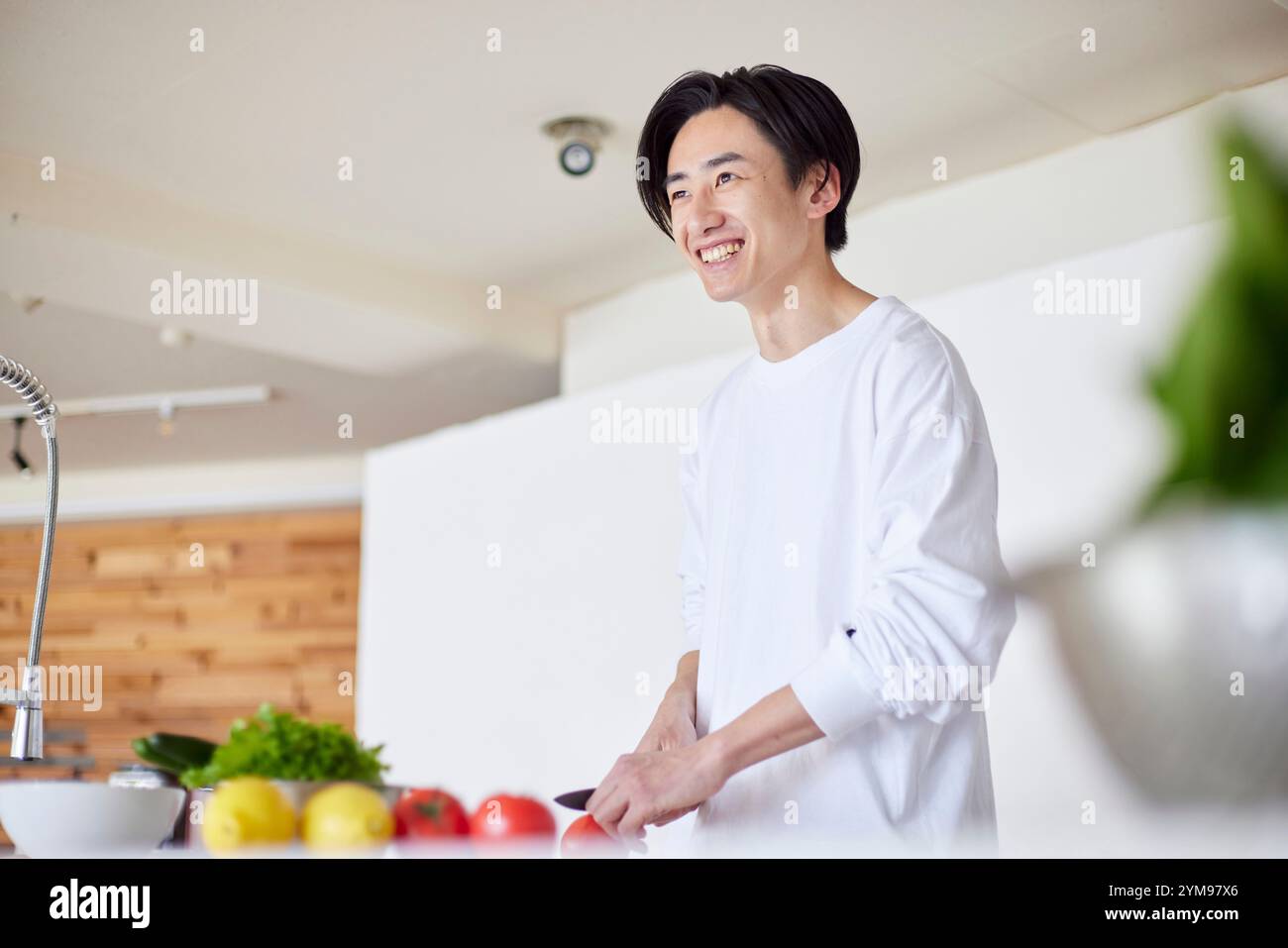 Young Japanese man cooking in the kitchen Stock Photo - Alamy