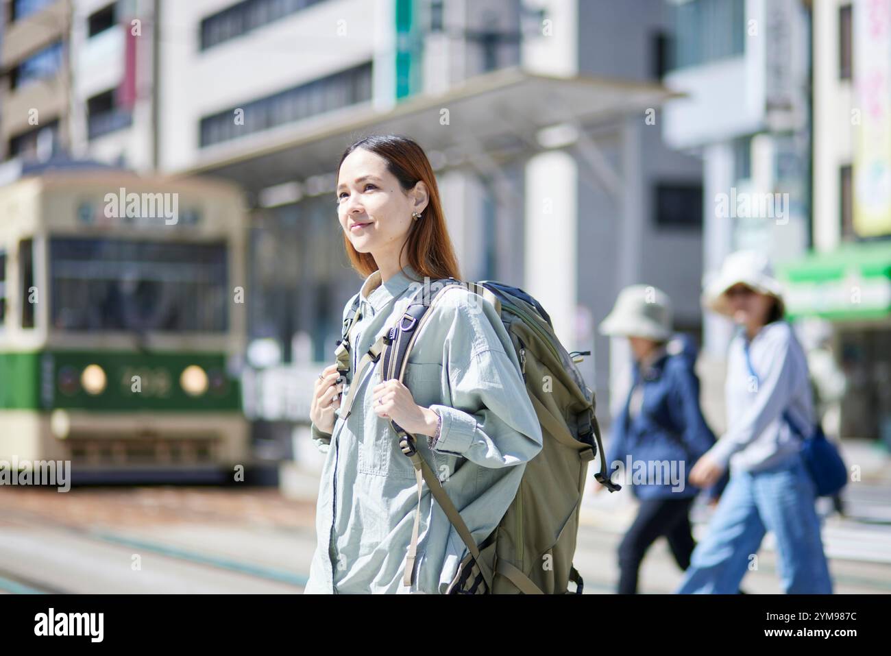 Female inbound backpacker walking with backpack on her back Stock Photo ...