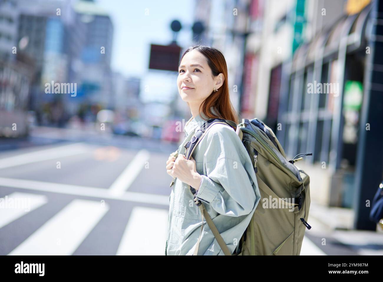 Female inbound backpacker walking with backpack on her back Stock Photo ...