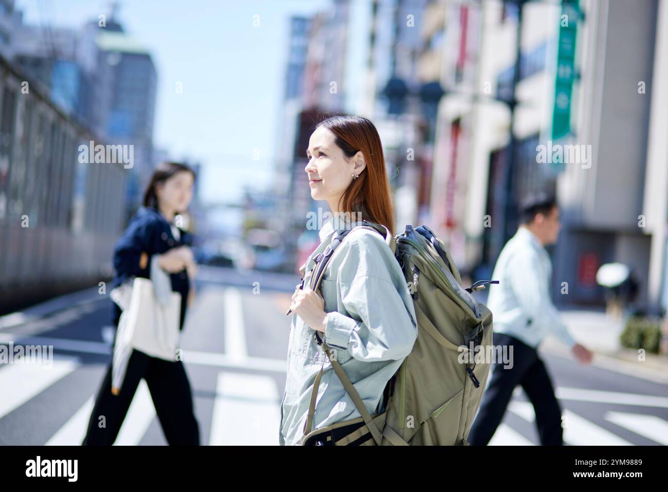 Female inbound backpacker walking with backpack on her back Stock Photo ...