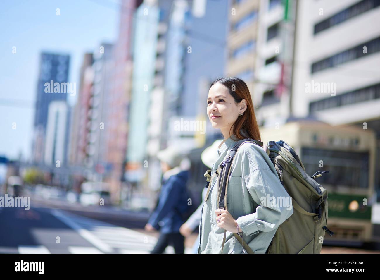 Female inbound backpacker walking with backpack on her back Stock Photo ...