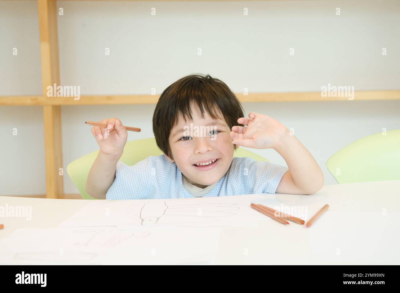 Laughing child wearing a smock Stock Photo - Alamy