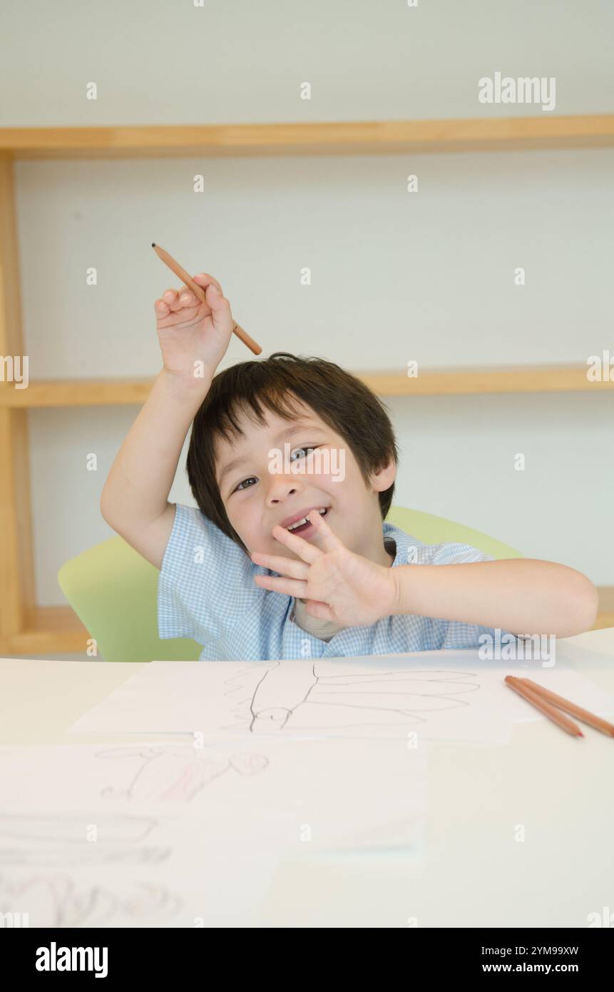 Laughing child wearing a smock Stock Photo - Alamy