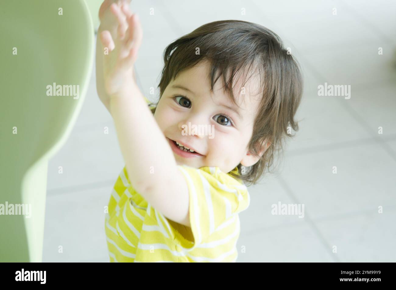 Smiling child extending hand Stock Photo - Alamy