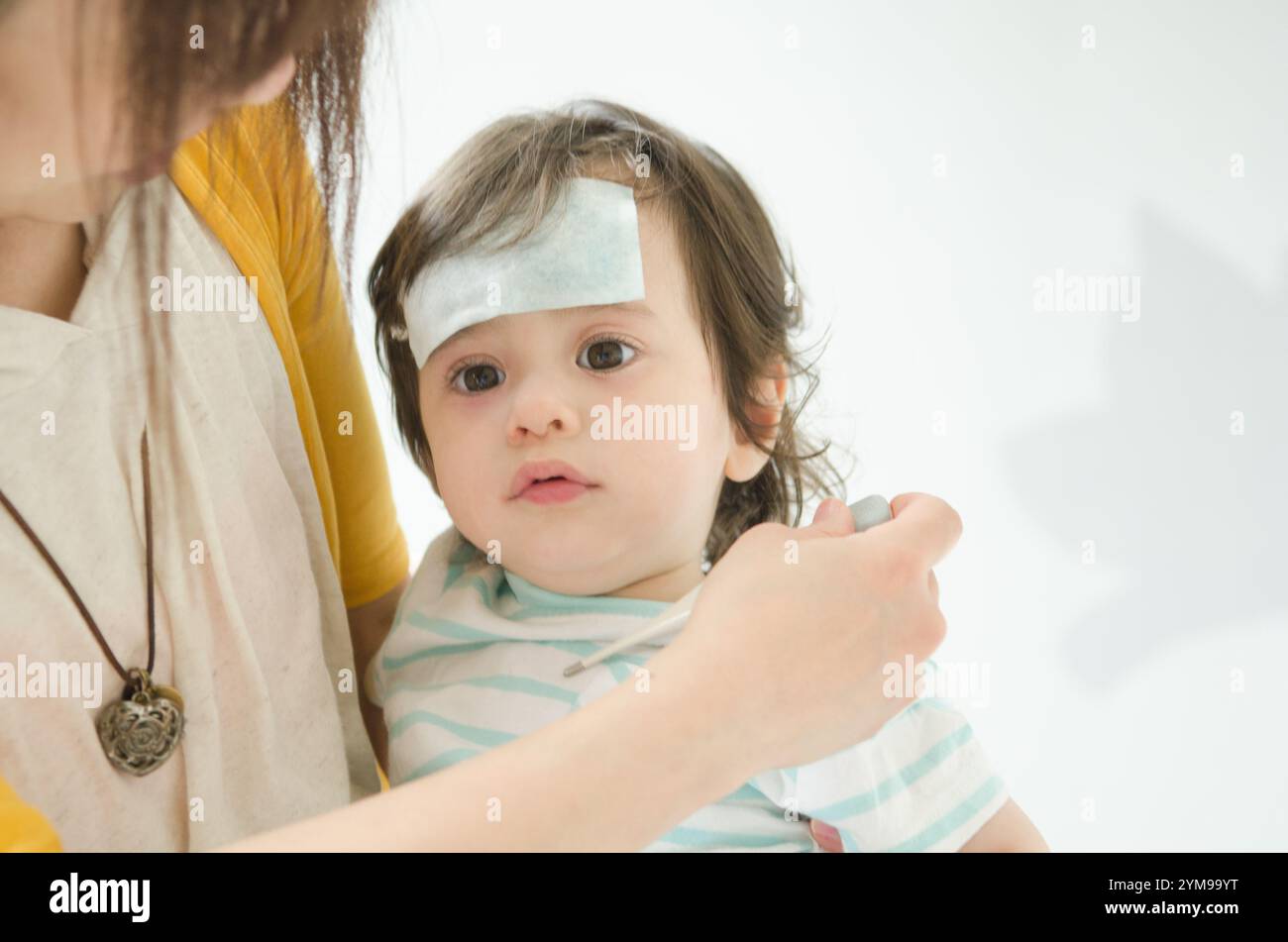 Sick child being carried Stock Photo - Alamy