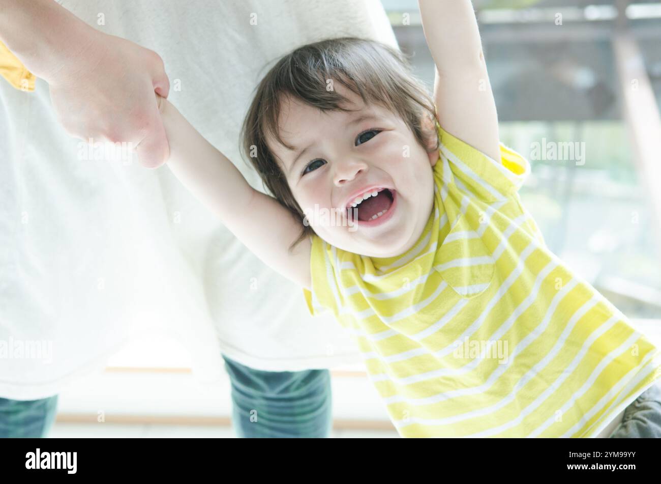 Parents and children playing inside a house Stock Photo - Alamy