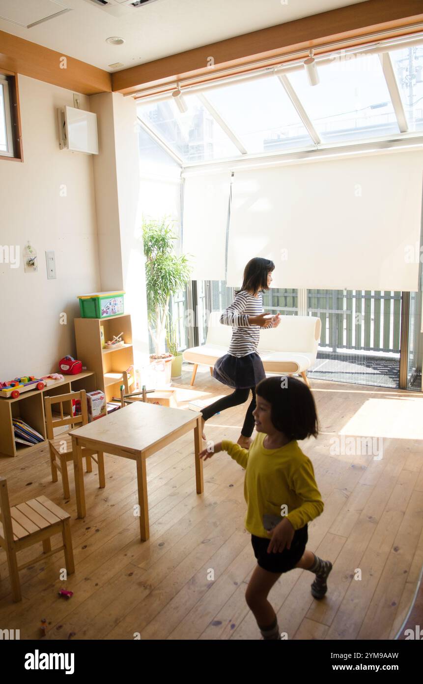 Sisters playing inside a house Stock Photo - Alamy