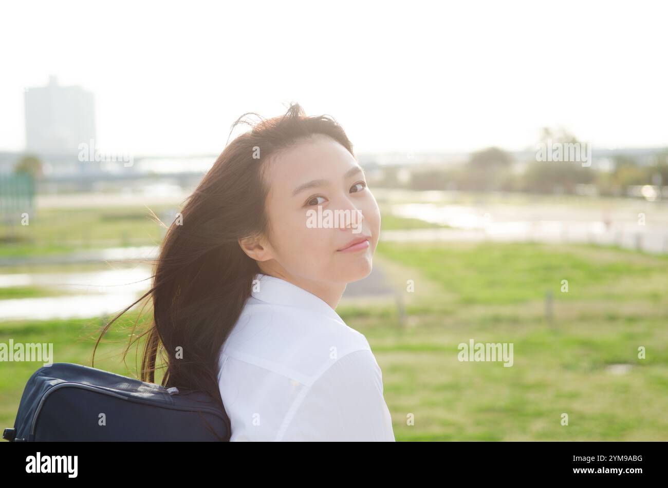 Female student looking back Stock Photo - Alamy
