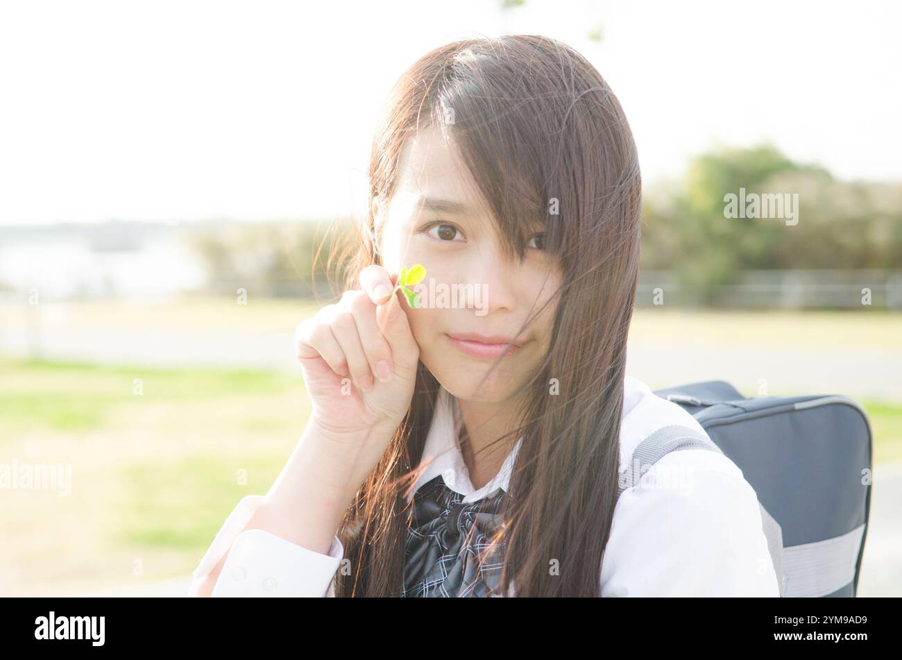 Female student holding clover Stock Photo - Alamy
