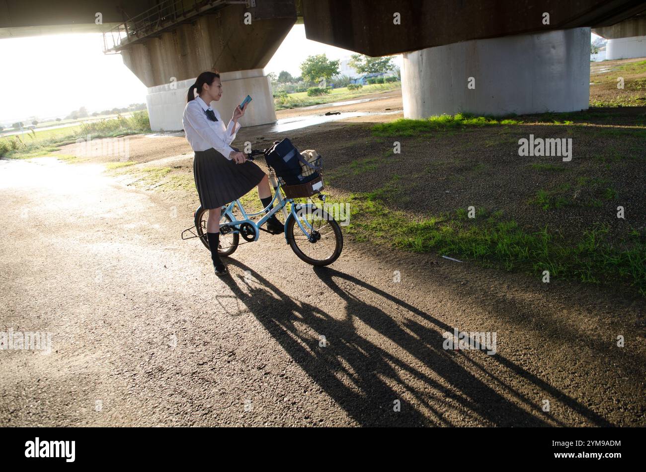Female student fiddling with her phone Stock Photo - Alamy