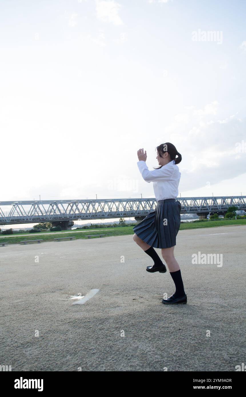 Female student pretending to throw the ball Stock Photo - Alamy