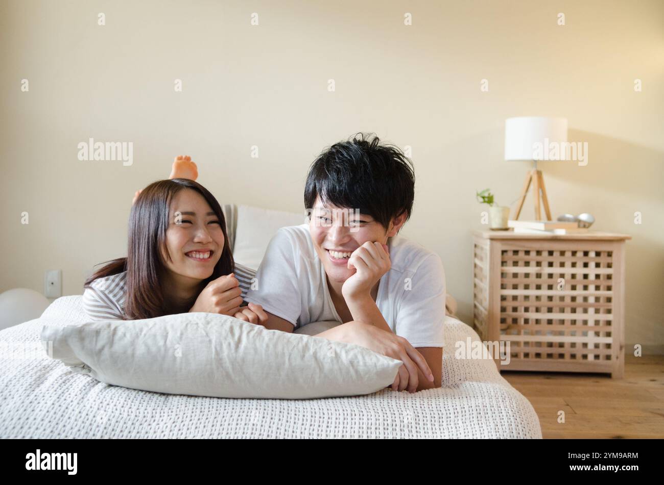 Laughing couple on bed Stock Photo - Alamy