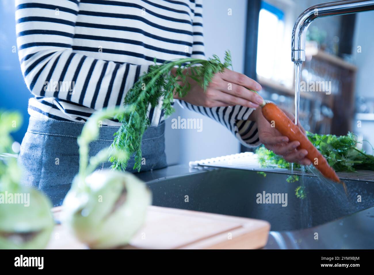 Hand of woman washing vegetables in kitchen Stock Photo - Alamy