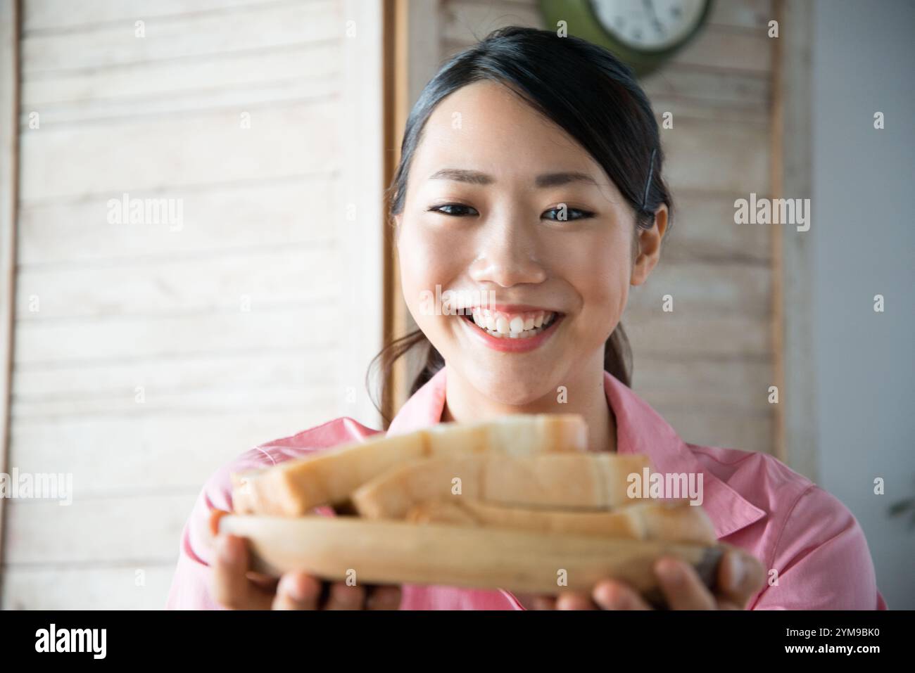 Woman laughing with a loaf of bread Stock Photo - Alamy
