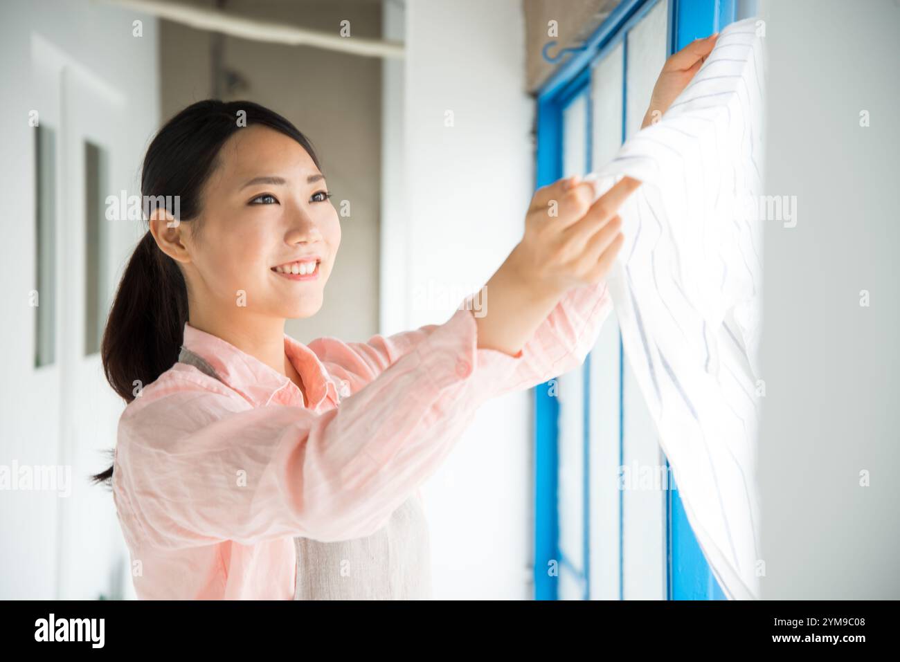 Woman touching towel hi-res stock photography and images - Alamy