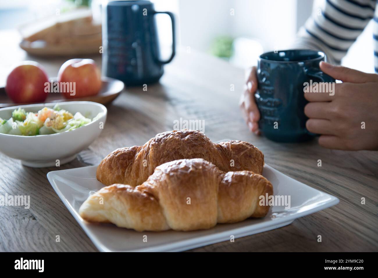 Breakfast scenery and woman's hand Stock Photo - Alamy