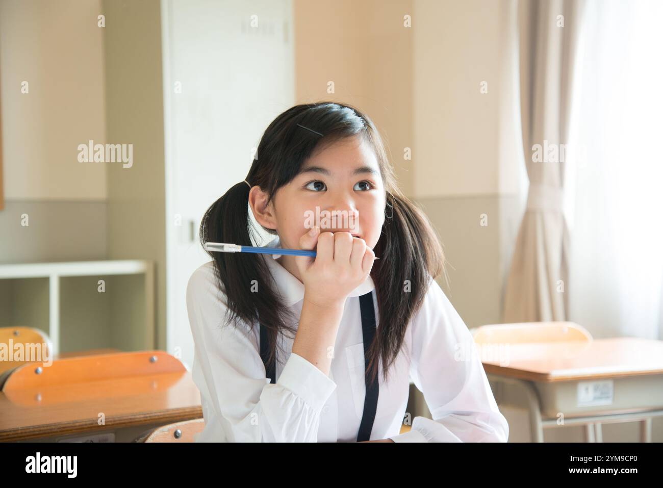 Primary school girls in school uniform in the classroom Stock Photo - Alamy